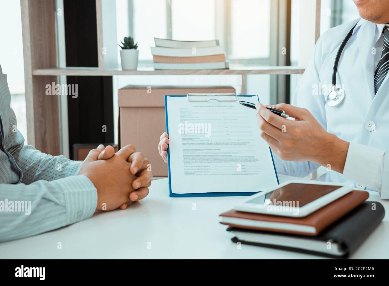 Confident female doctor reviews patient medical information and ...