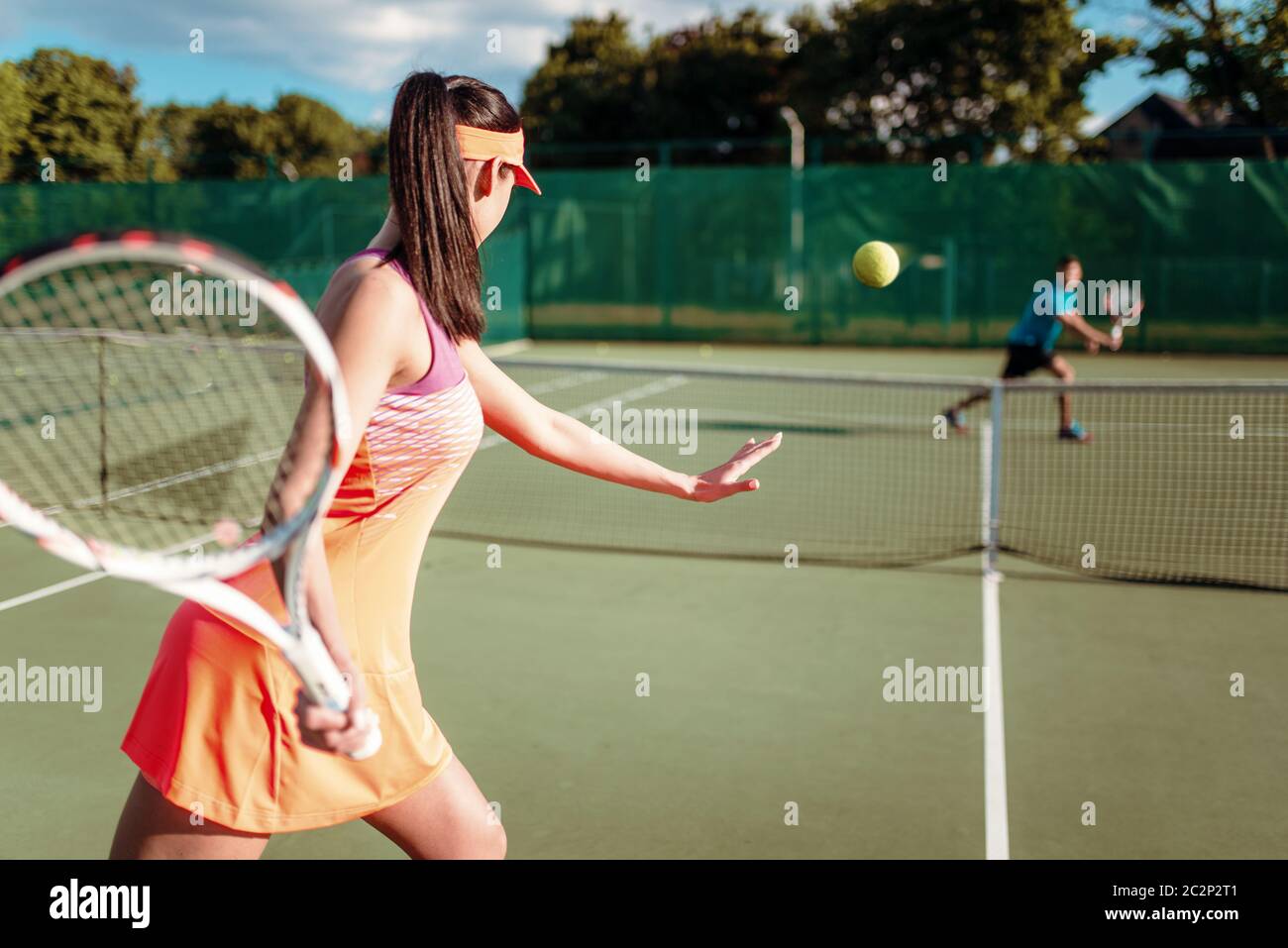 Couple playing tennis on outdoor court. Summer season active sport game ...