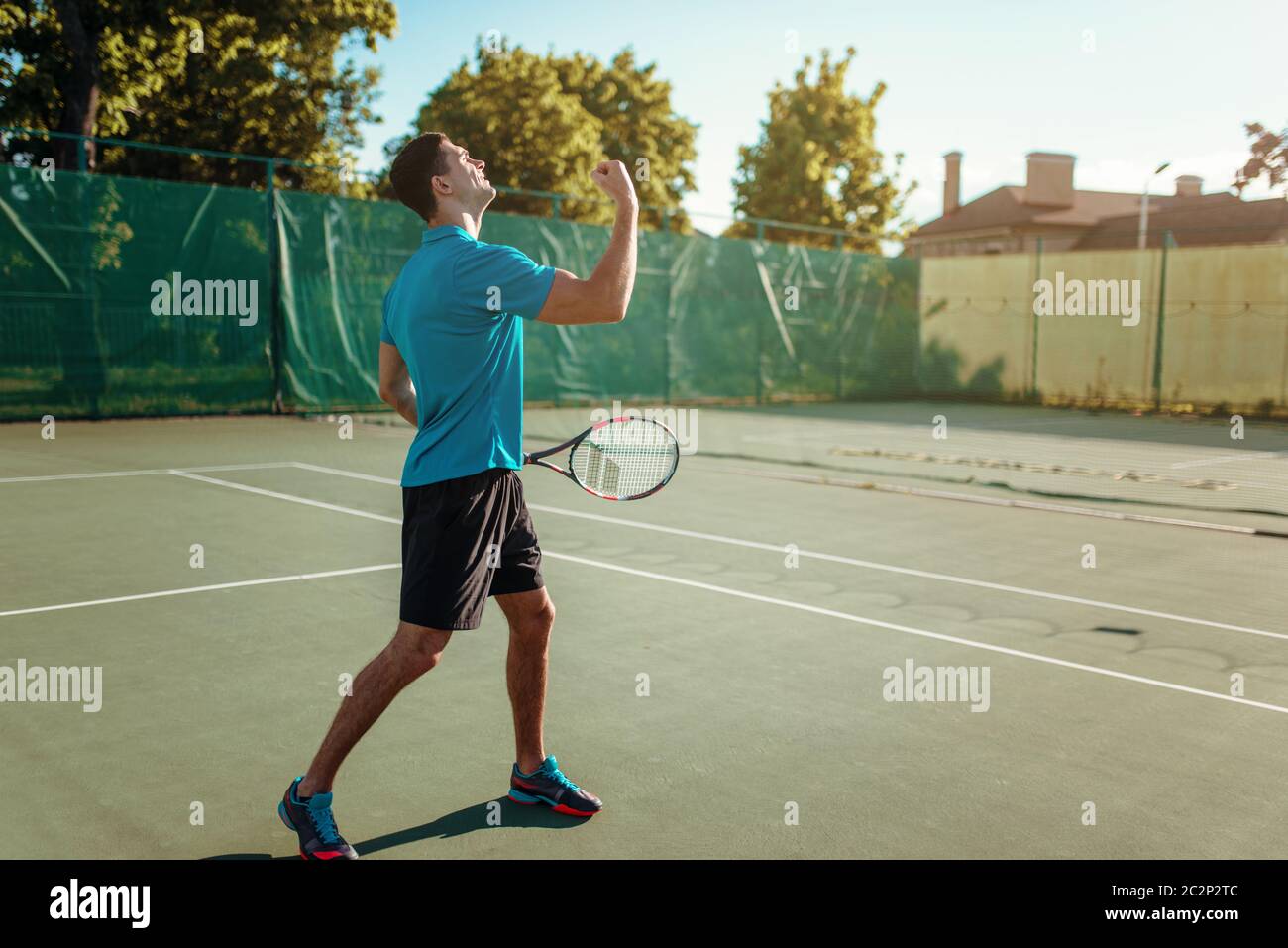 Man with tennis racket on outdoor court. Summer season active sport ...