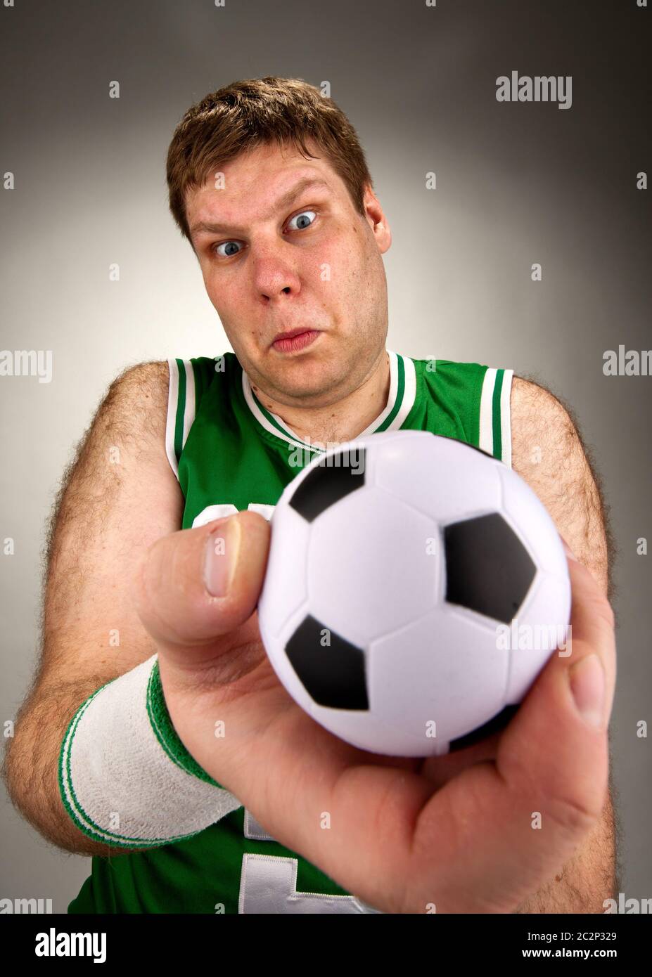 Portrait of surprised basketball player with football Stock Photo - Alamy