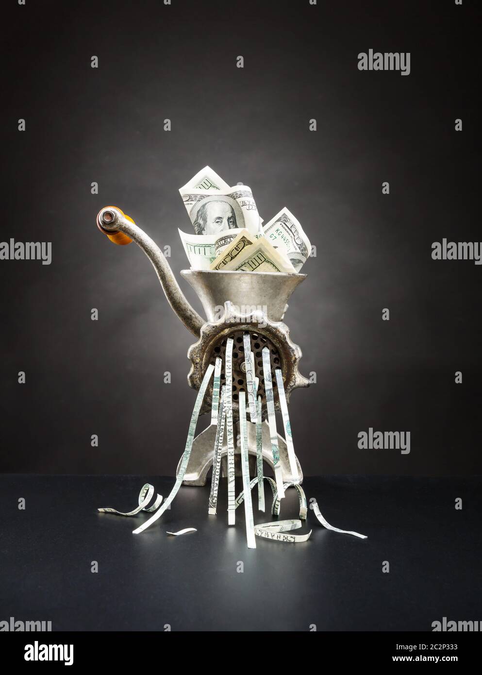 Mincing machine is grinding up money Stock Photo - Alamy