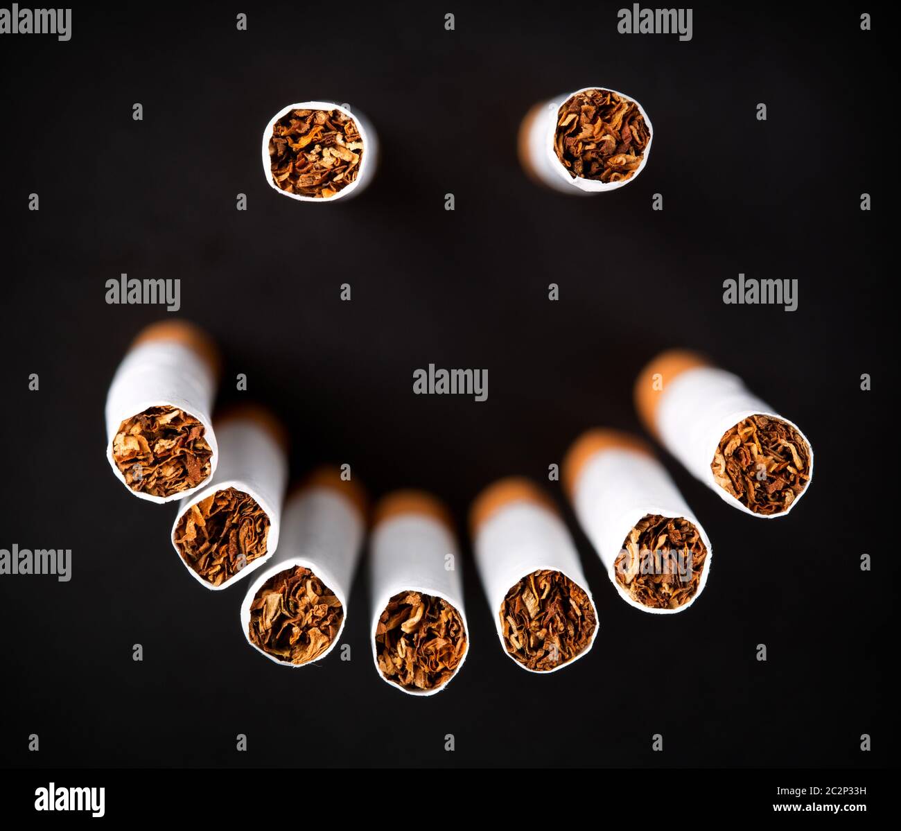 Smiley face made of cigarettes. Closeup view Stock Photo - Alamy