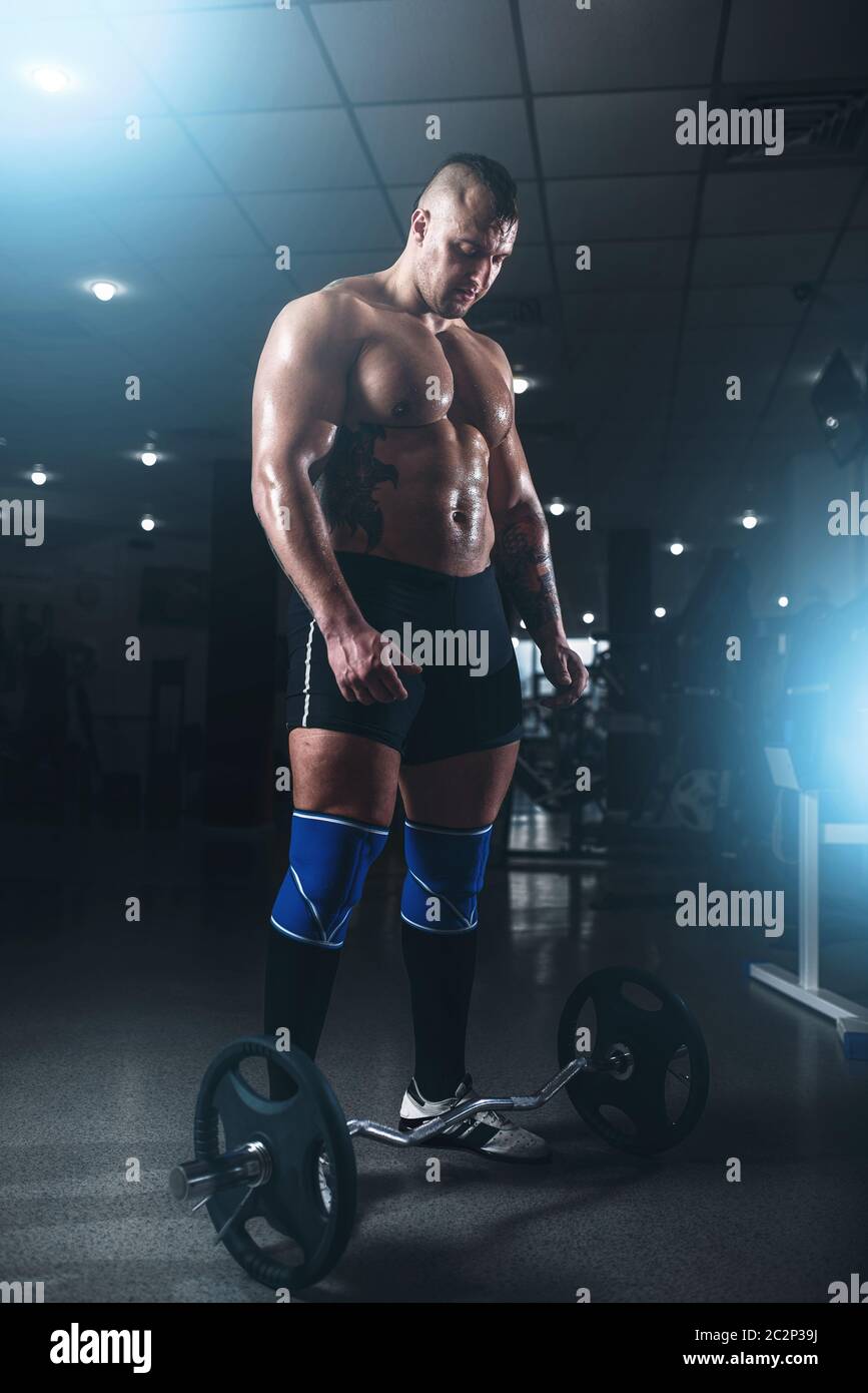 Strong athlete exercise with weight in fit gym. Fitness training with ...