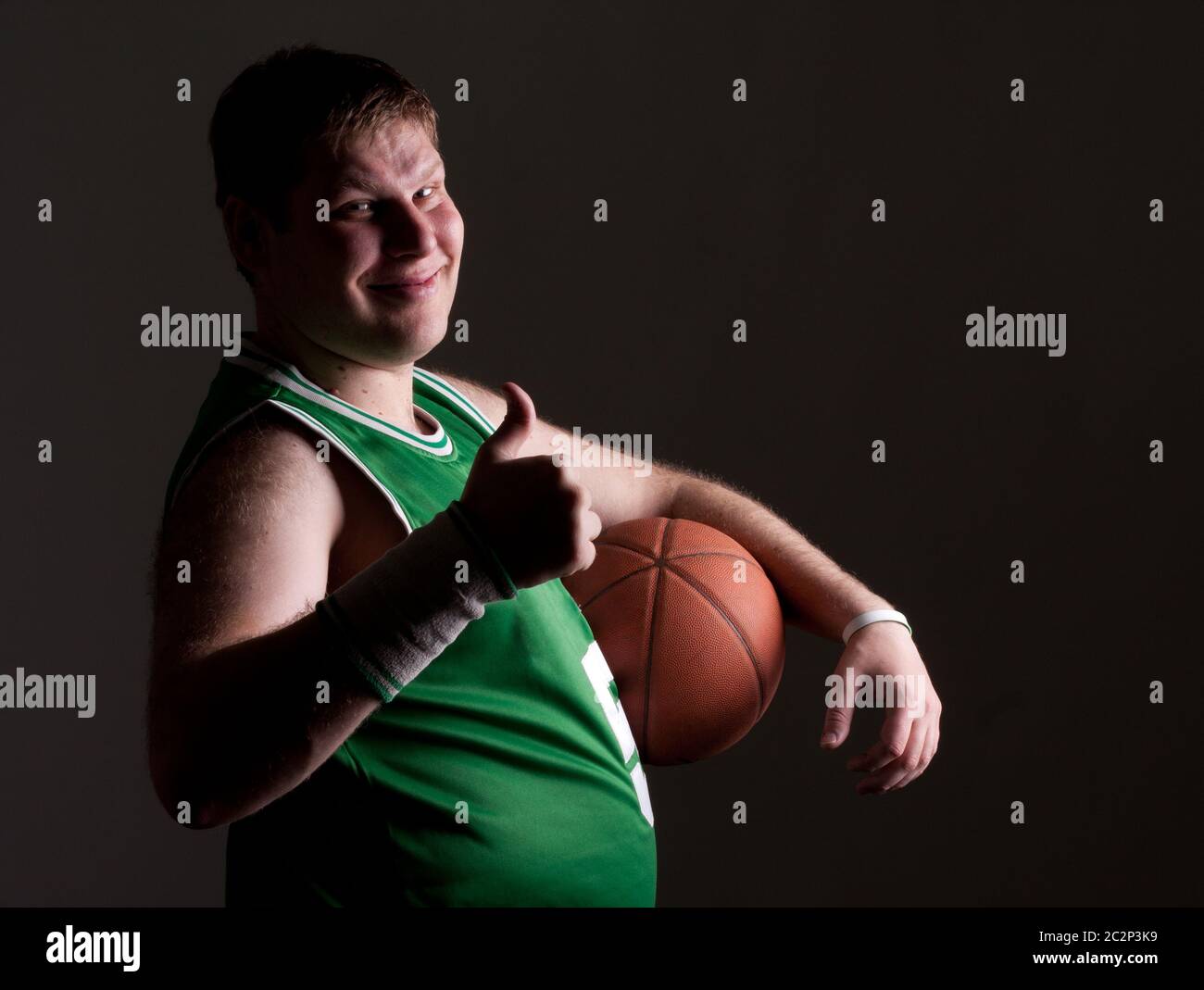 Portrait of basketball player with ball showing OK sign Stock Photo - Alamy