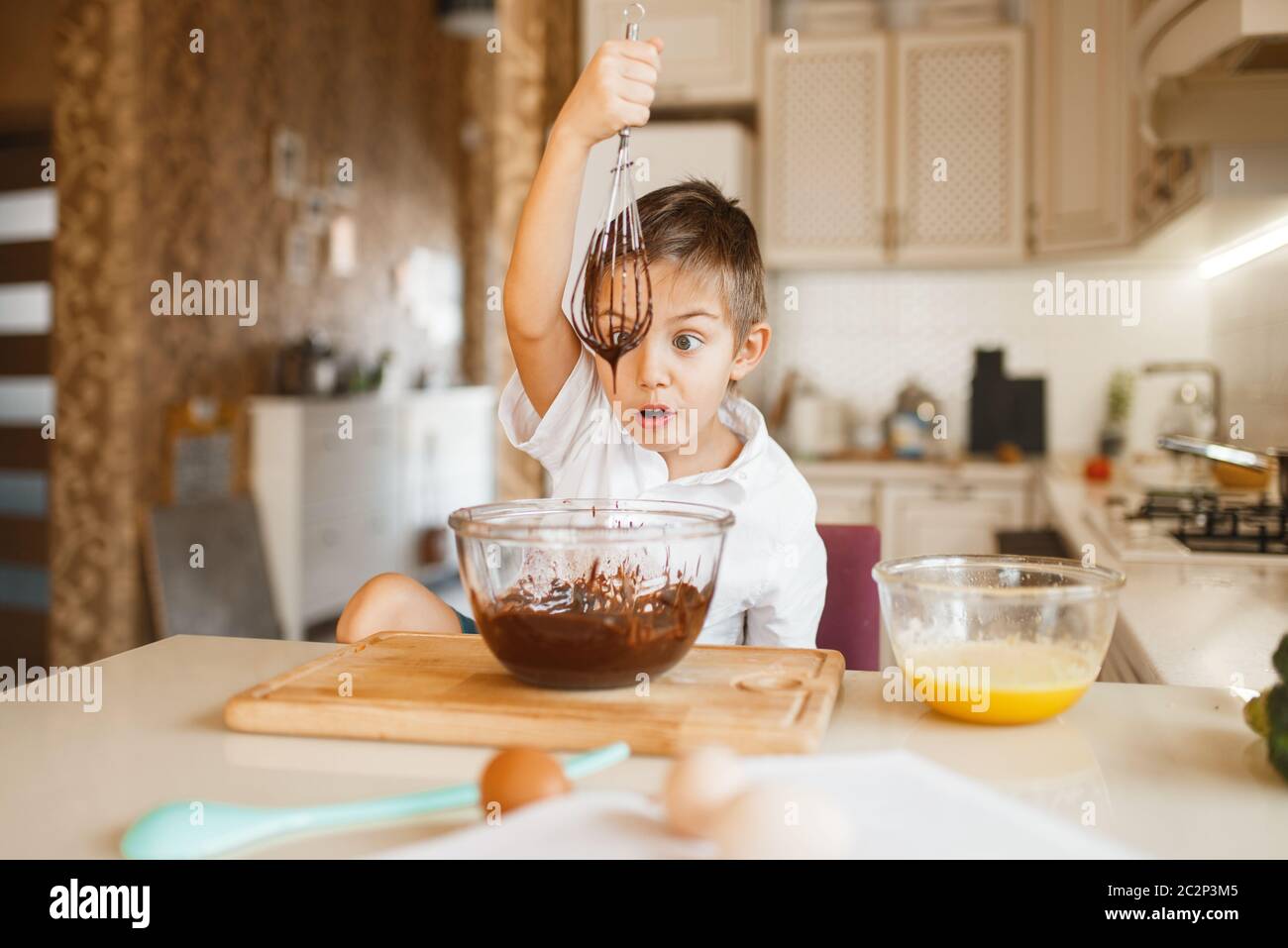 Boy mixing chocolate in kitchen hi-res stock photography and images - Alamy