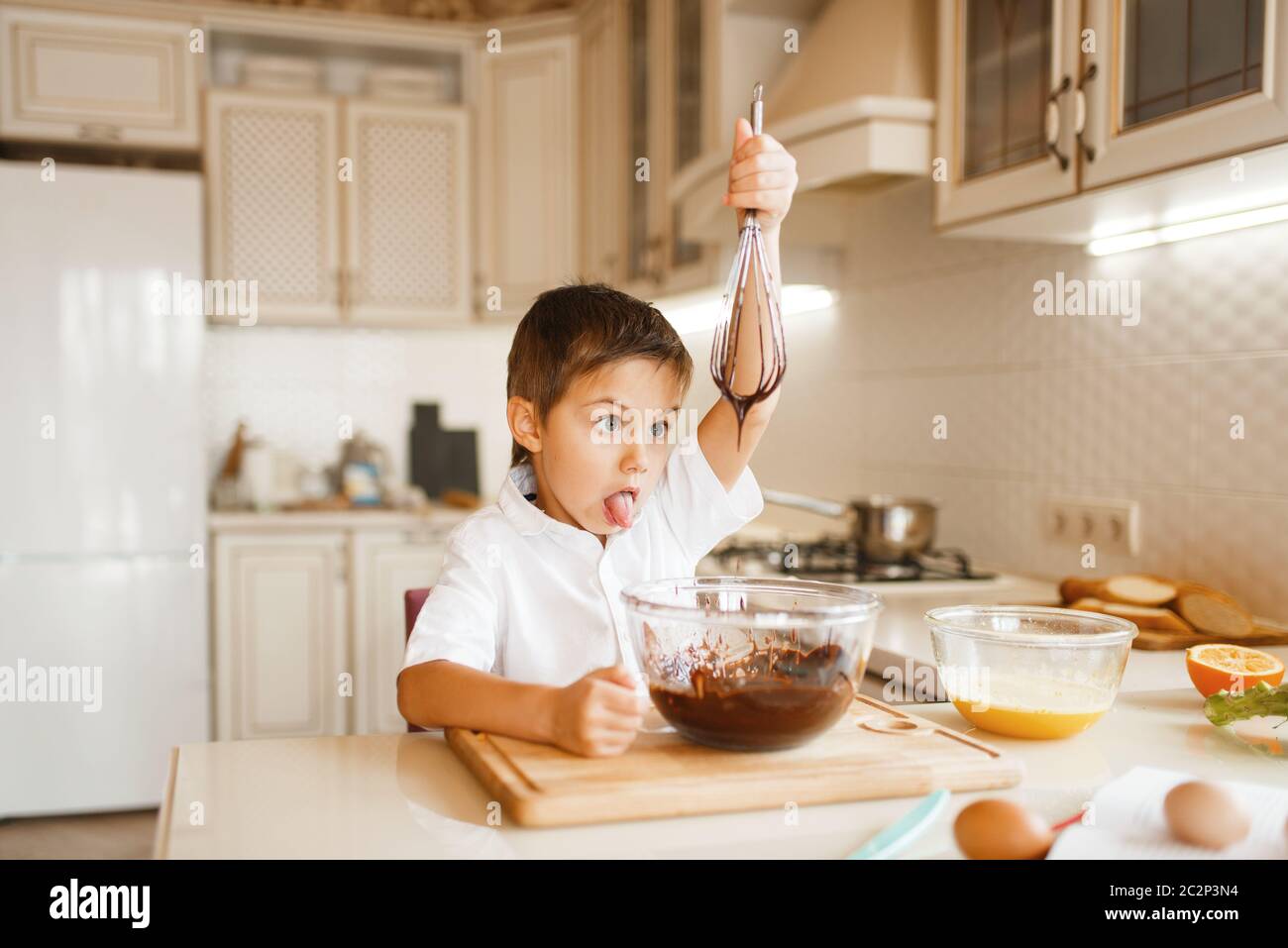 Boy mixing chocolate in kitchen hi-res stock photography and images - Alamy