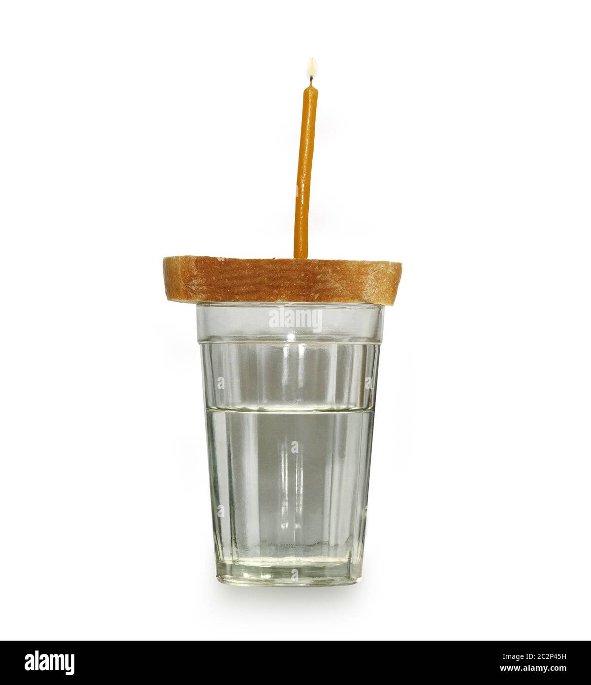 Glass of water and bread and candle Stock Photo - Alamy