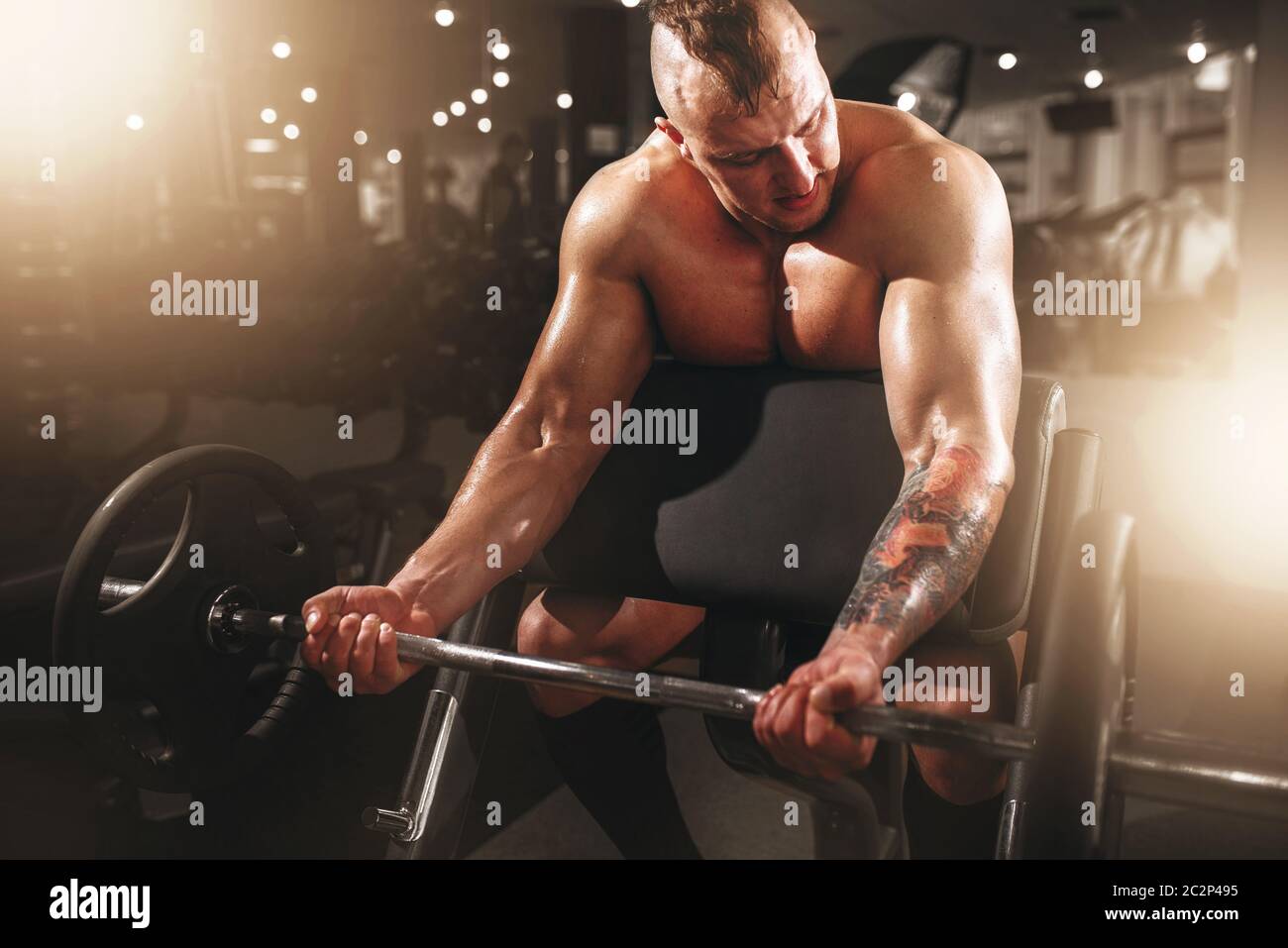 Strong athlete with muscular body lifting barbell, bodybuilding workout ...