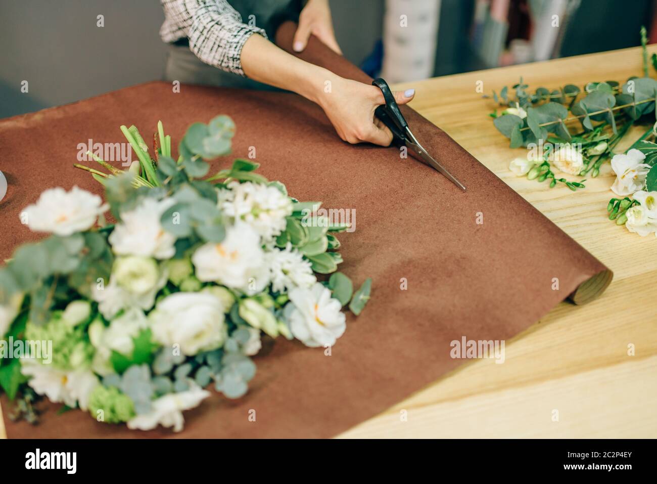 Female florist hands cuts flower decoration with scissors. Floral ...