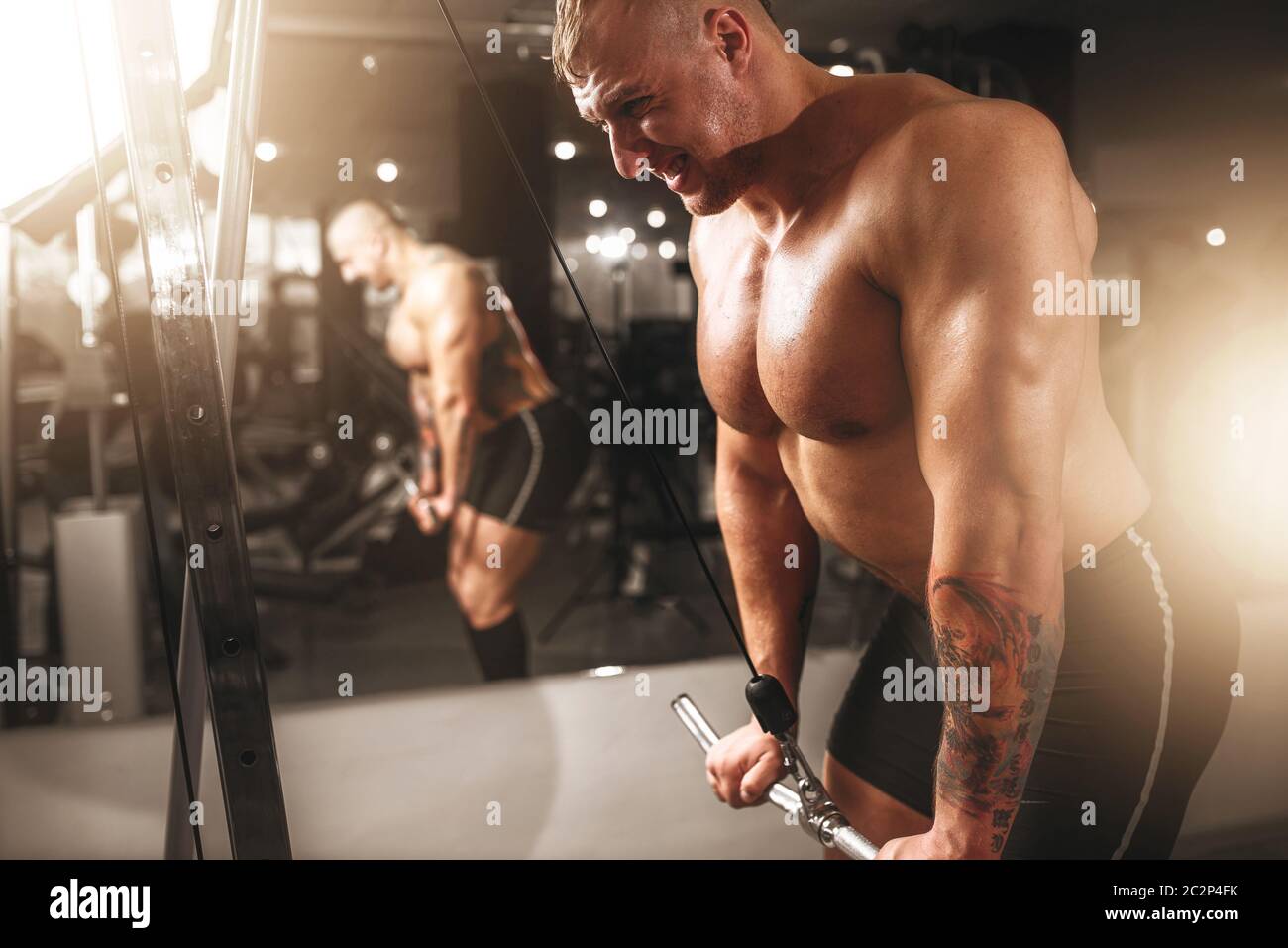 Strong athlete with muscular body lifting barbell, bodybuilding workout ...