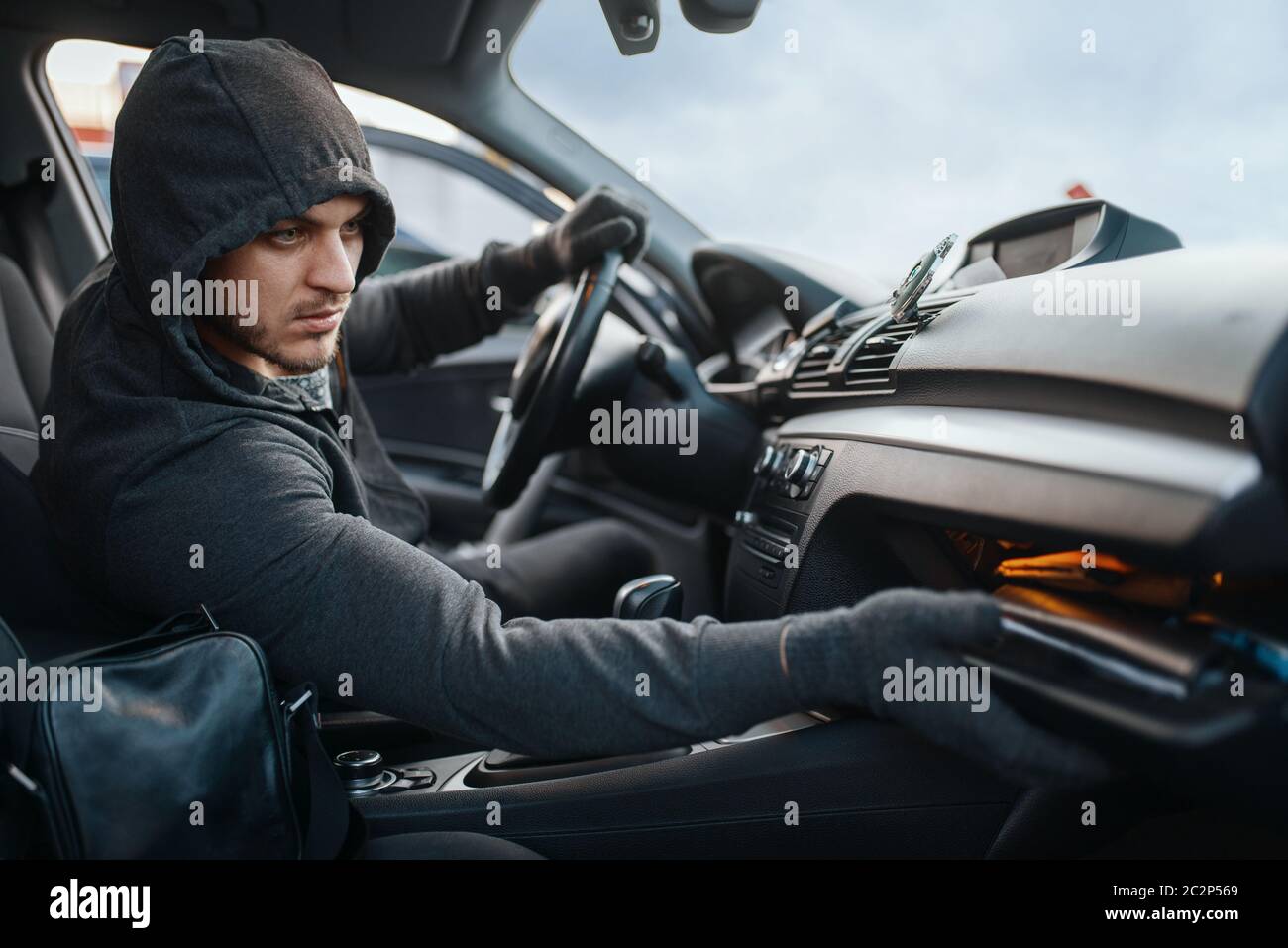 Car robber searches the glove compartment, dangerous hobby, stealing ...