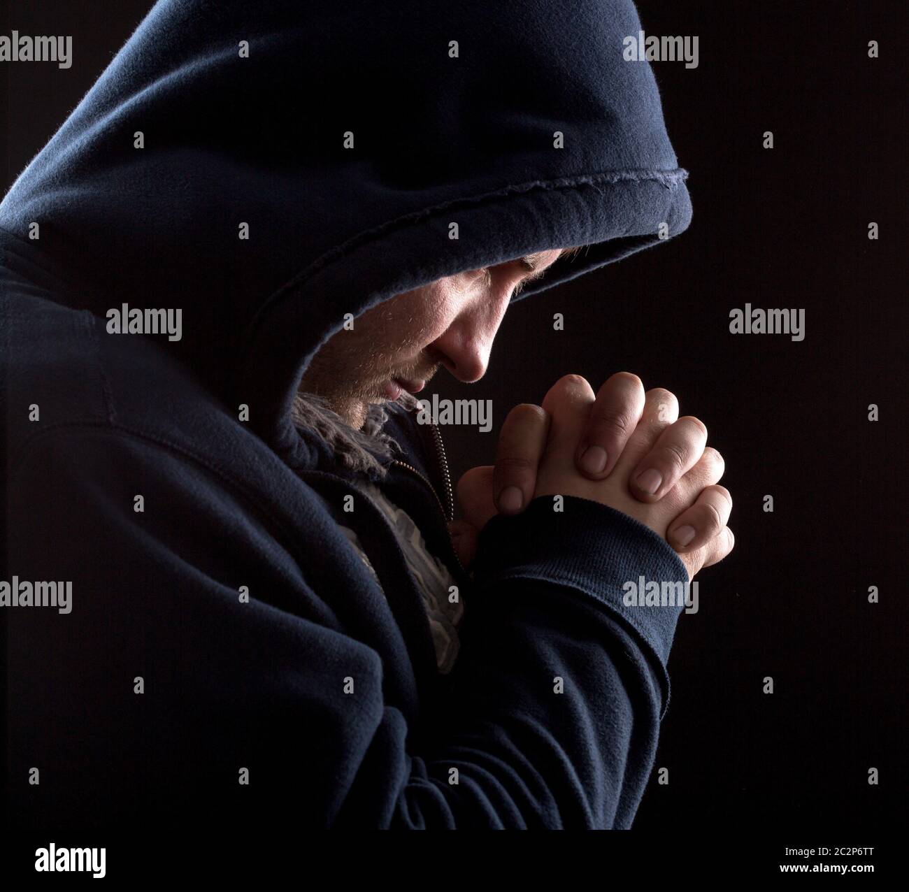 Despair bandit praying God for forgiveness Stock Photo - Alamy