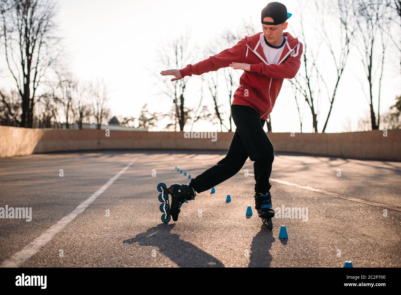Roller skater rides the snake, rollerskating speed exercise in park ...