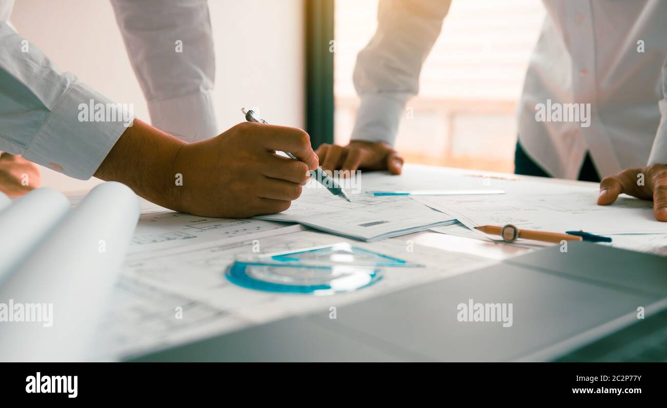 Engineering man showing blueprint detail for people buying house Stock ...