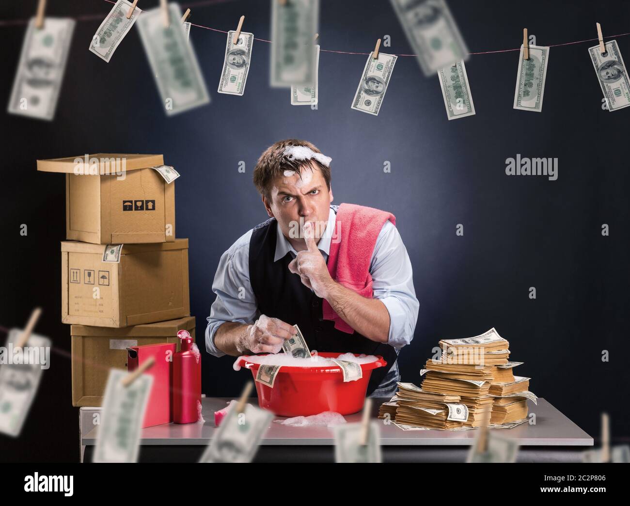 Businessman is laundering money banknotes in foam in red washbowl Stock ...