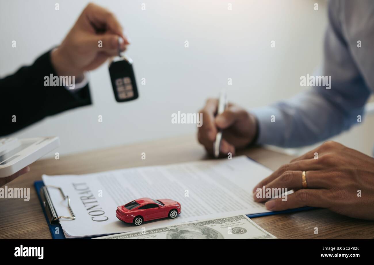 New car buyers sign contract documents for new car purchases at the ...