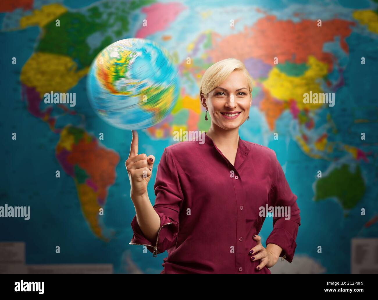 Travel agent woman with a globe against a map of the world Stock Photo ...