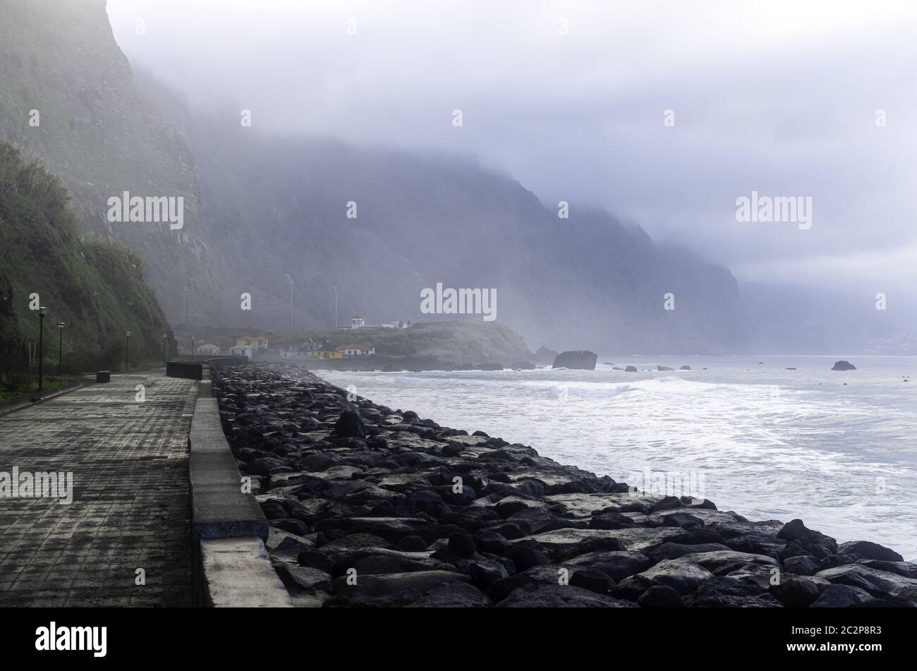 Path between the mountain and the ocean shore Stock Photo - Alamy
