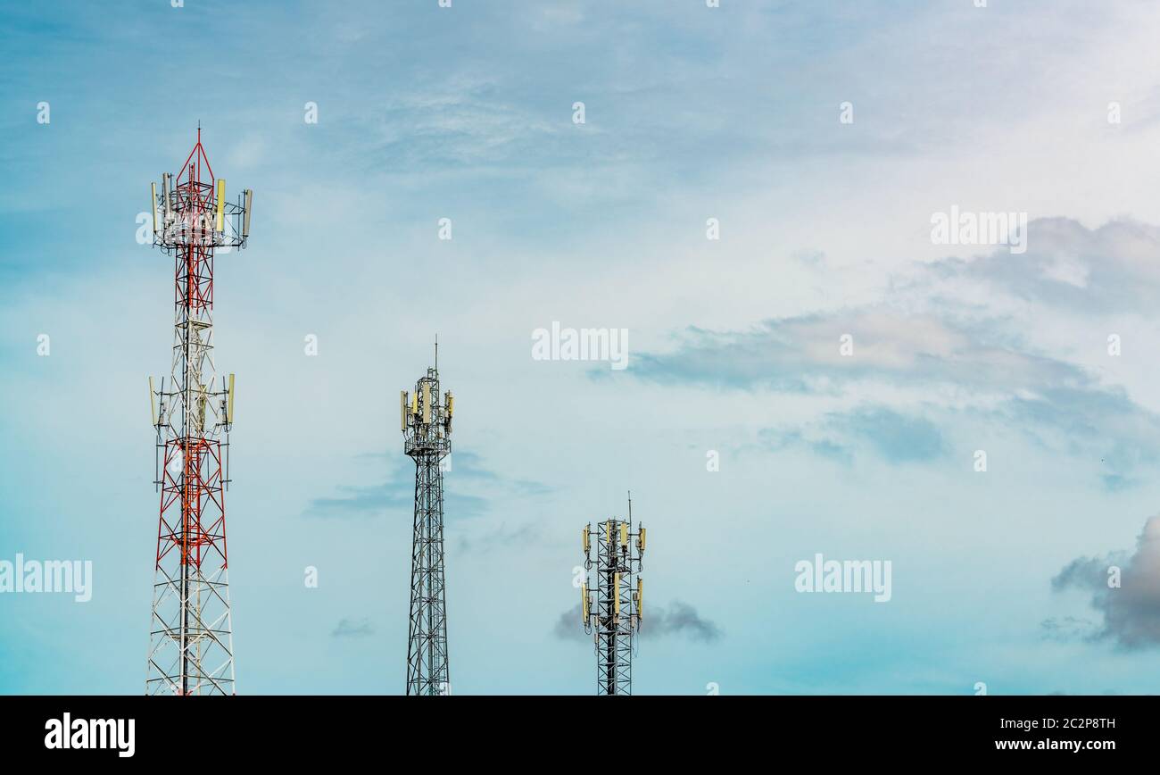 Telecommunication tower with blue sky and white clouds. Antenna on blue ...