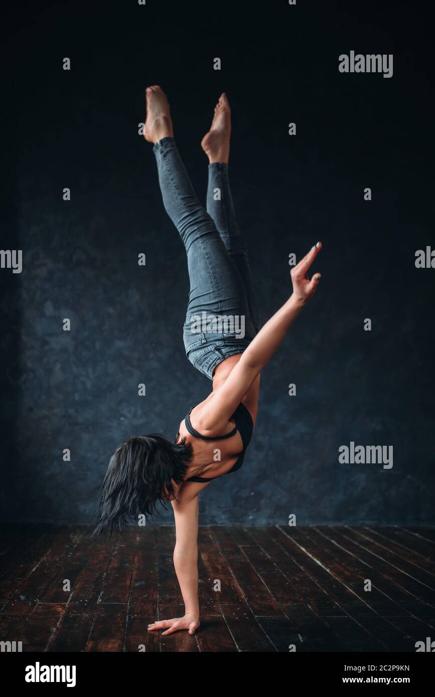Contemp dance gymnastic exercise in studio. Female dancer stands on one ...