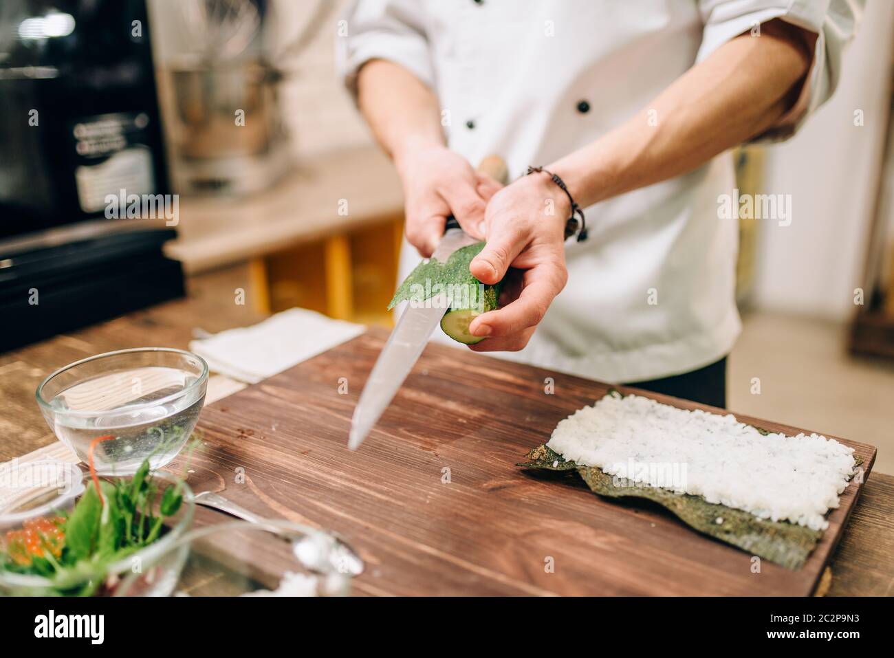 Sushi preparation process, traditional japanese cuisine. Male cook ...