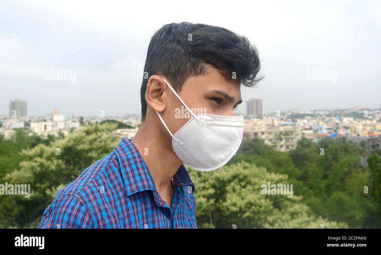 Side view of man wearing face mask on city background Stock Photo - Alamy