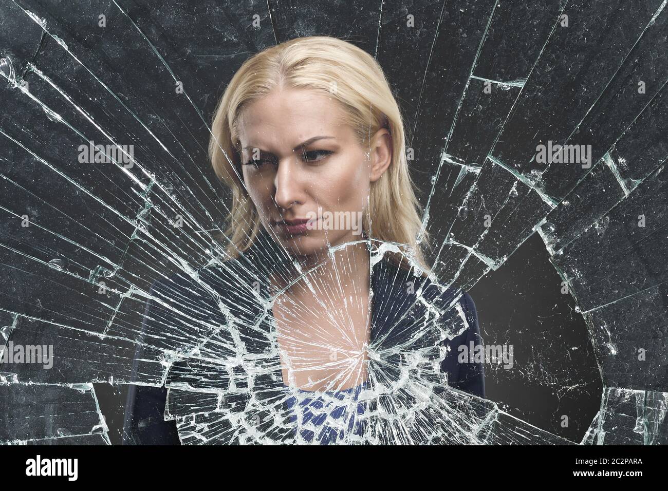 Depressed adult woman stands behind broken glass Stock Photo - Alamy