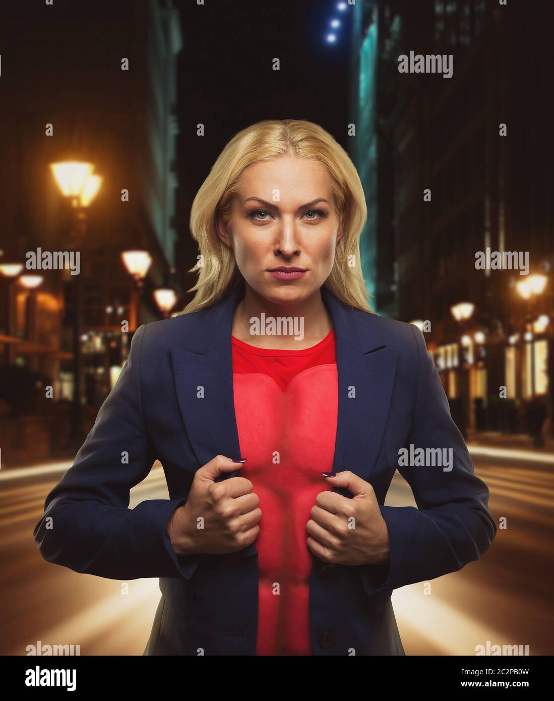 Strong woman superhero showing off her strength in night city street ...