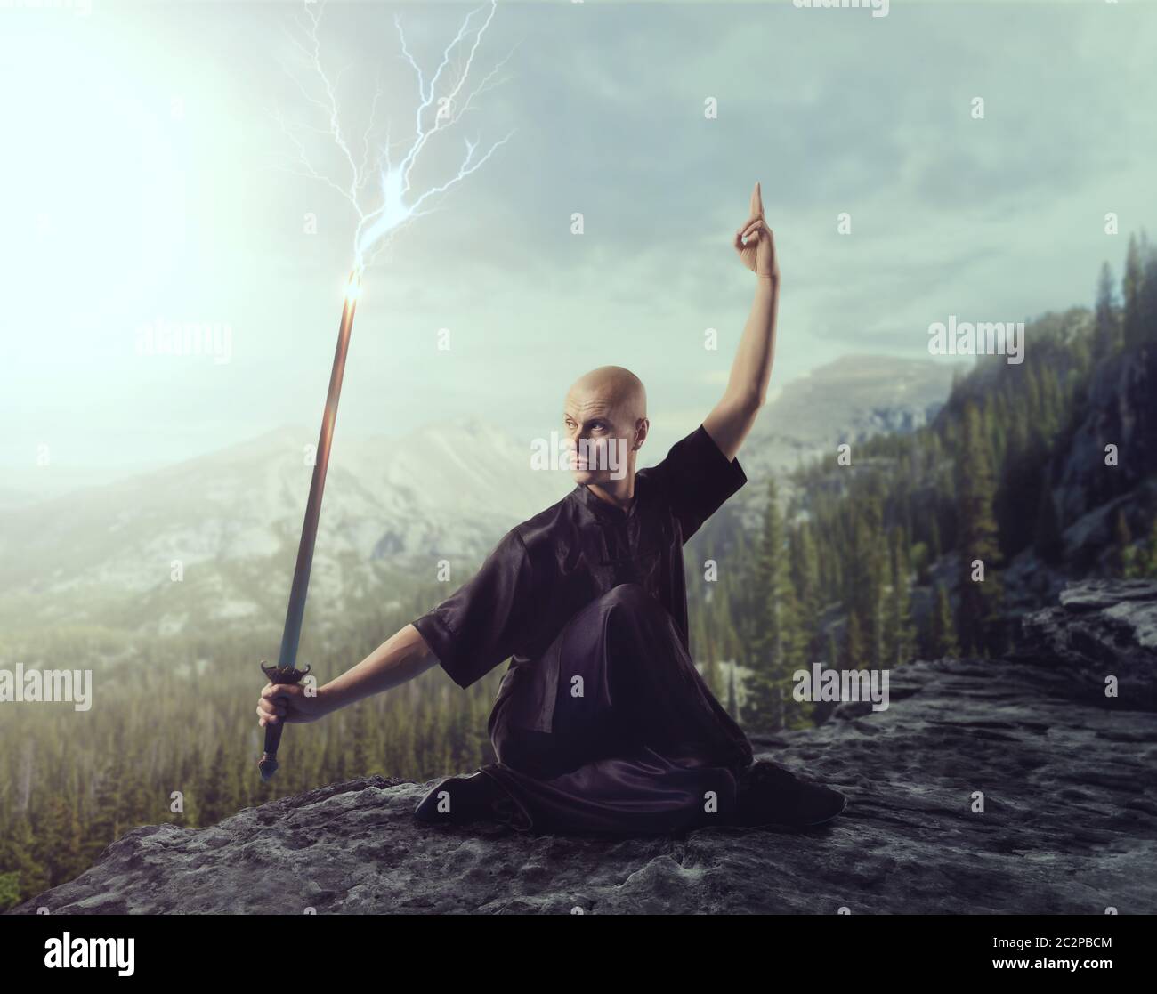 Wushu master with blade, lightning control on the top of mountain ...
