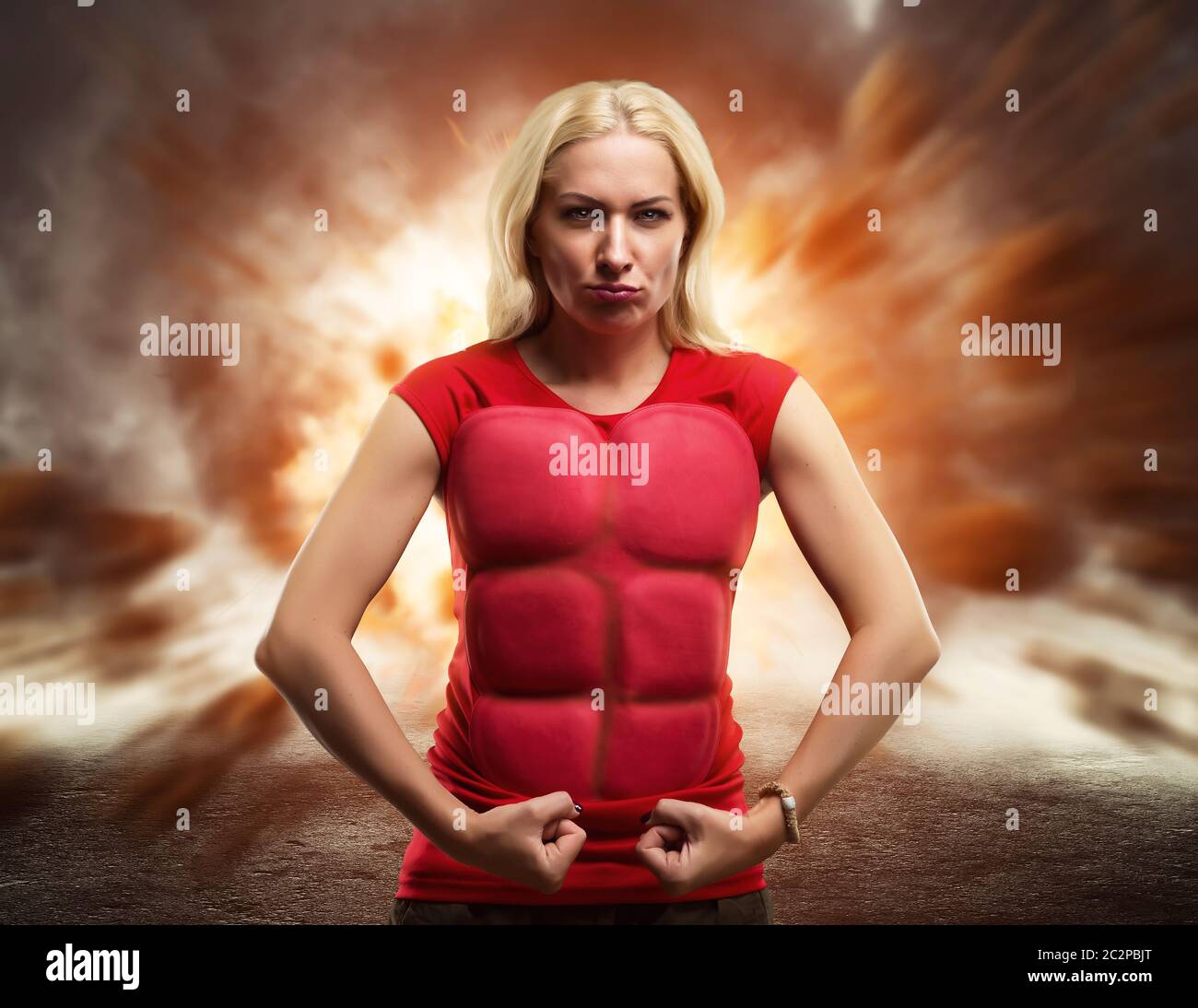 Strong woman superhero showing off her strength against burst of light ...