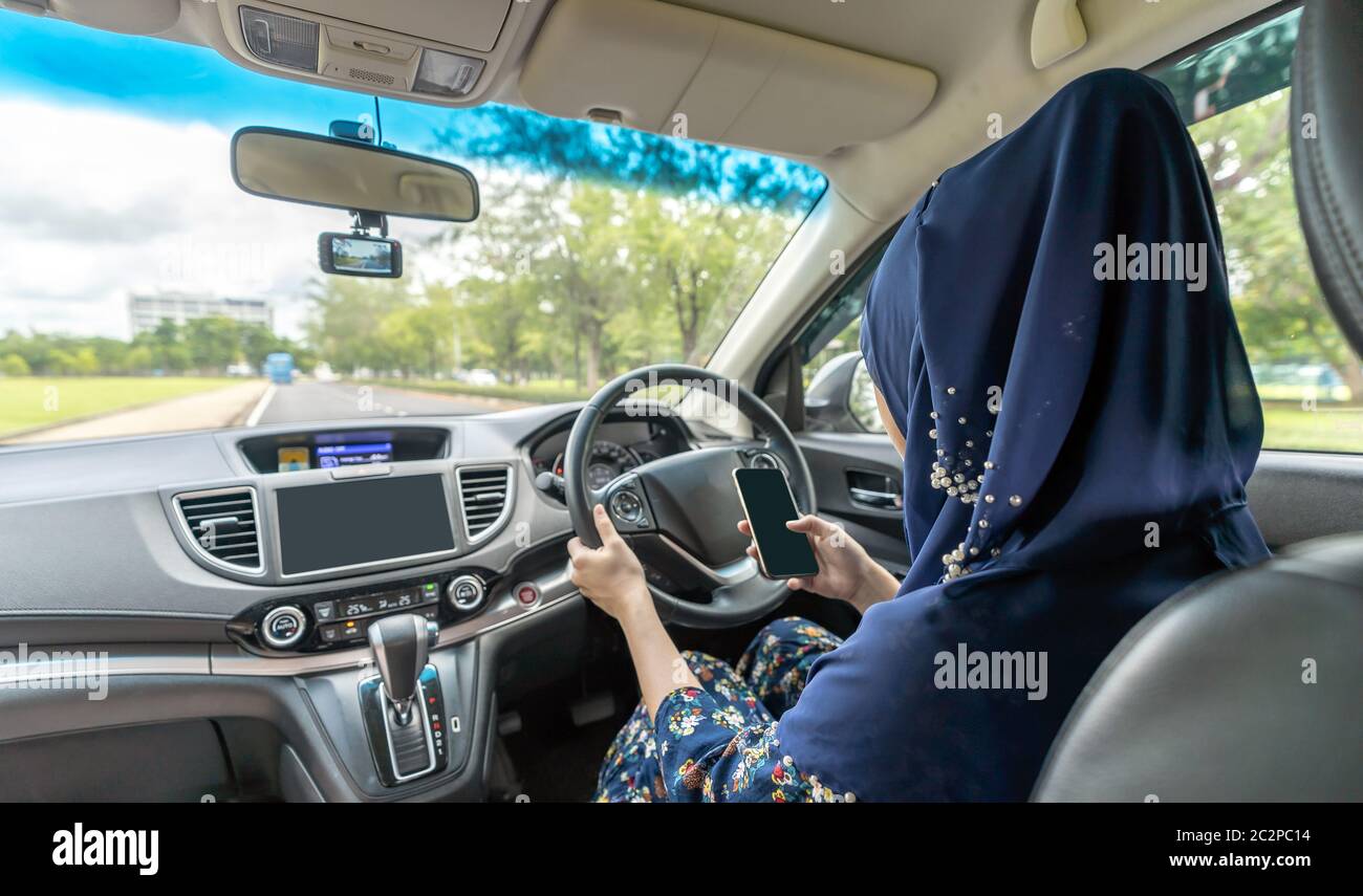 Back view of muslim lady girl driving car using mobile phone Stock ...
