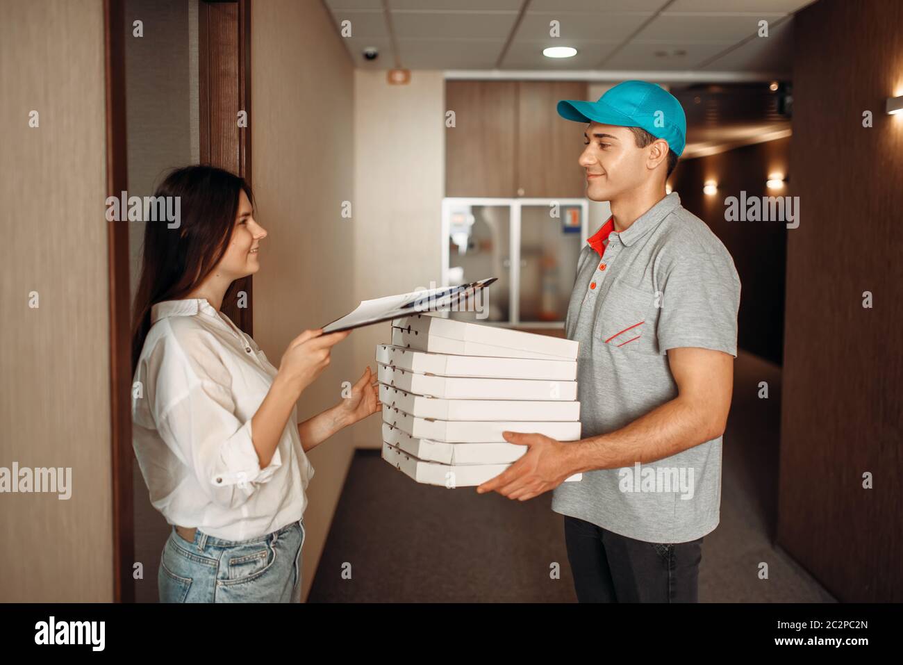 Female customer takes order from pizza delivery boy, fast delivering ...