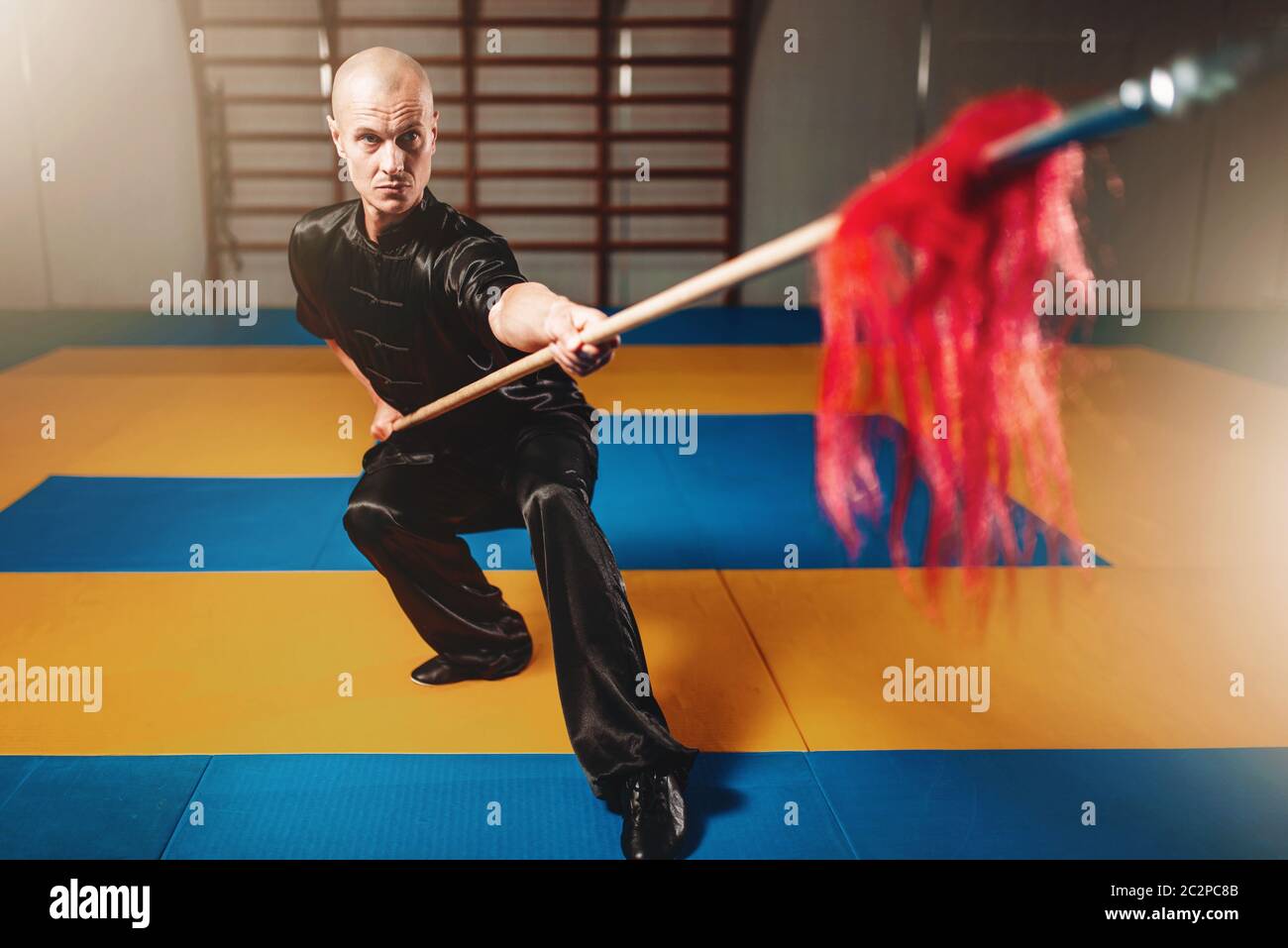 Wushu master training with spear, martial arts. Man in black cloth ...