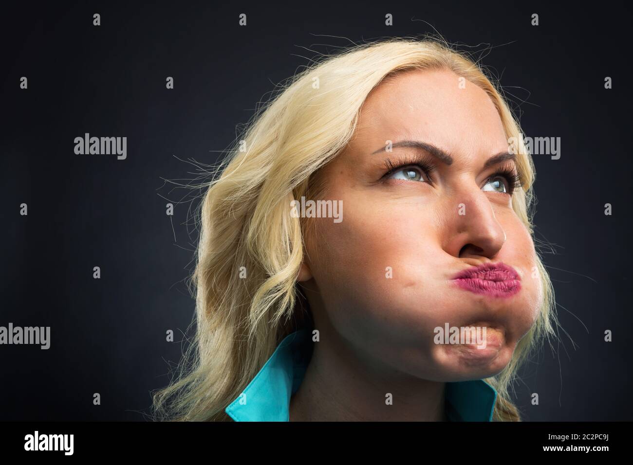 Woman blowing cheeks hi-res stock photography and images - Alamy