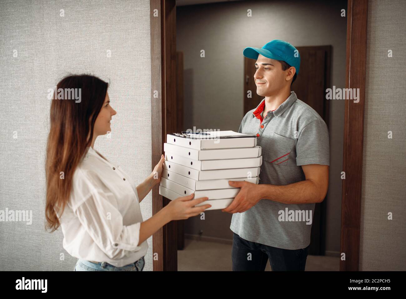 Female customer takes order from pizza delivery boy, fast delivering ...