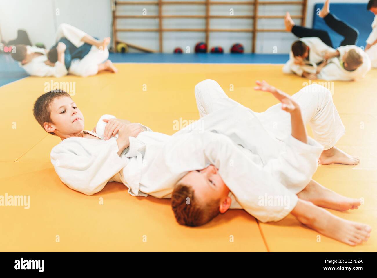 Little boys in uniform practice kid judo. Young fighters on training in ...