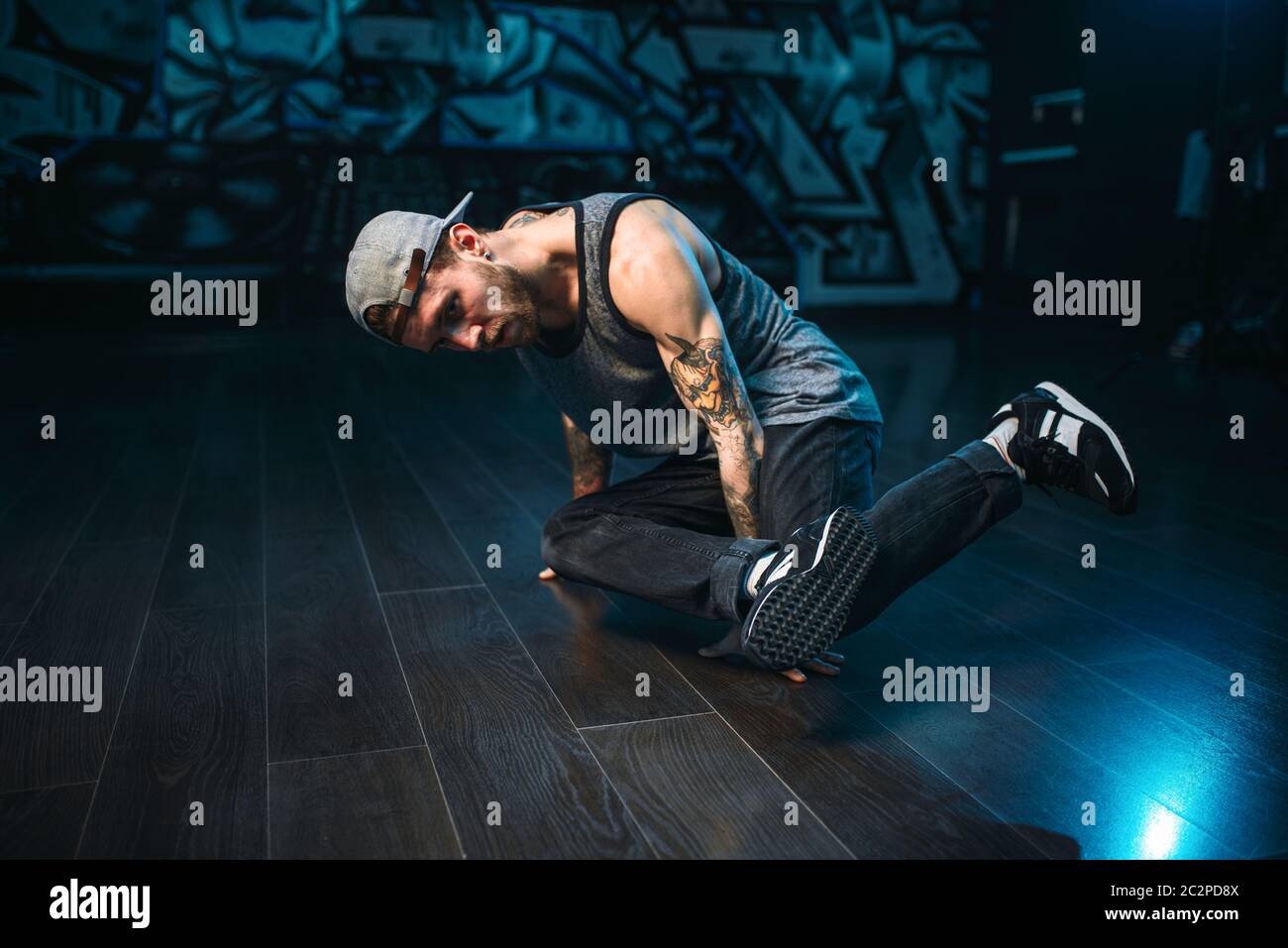 Breakdance performer posing in dance studio. Modern urban dancing style ...