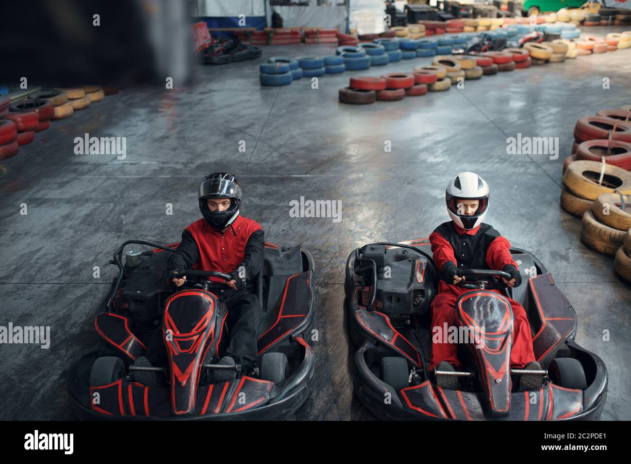Two kart racers on start line, front view, karting auto sport indoor ...