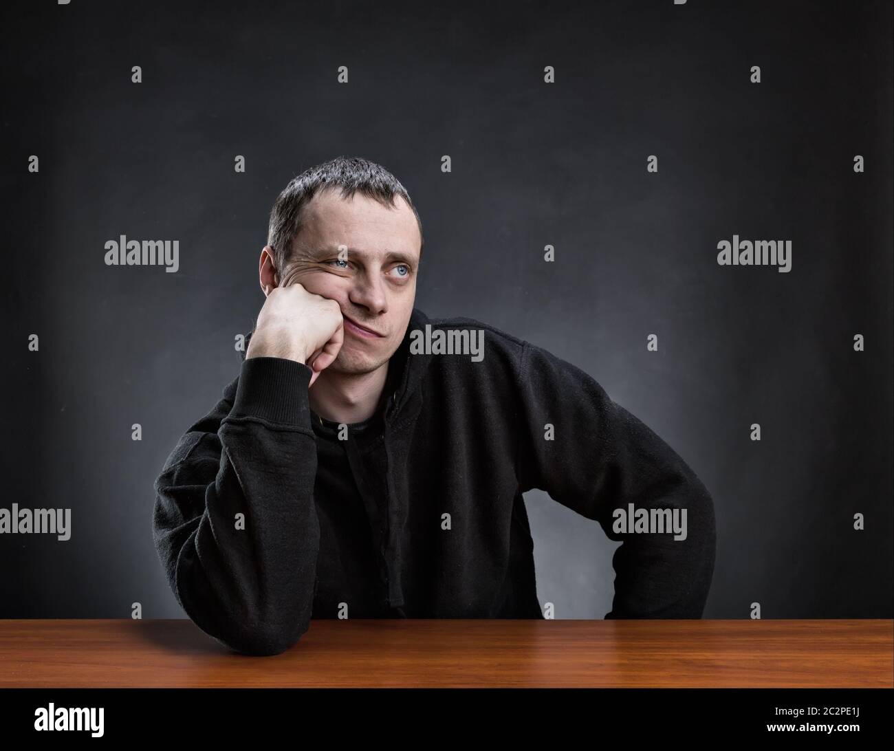 Pensive man with palm on his cheek thinks Stock Photo - Alamy