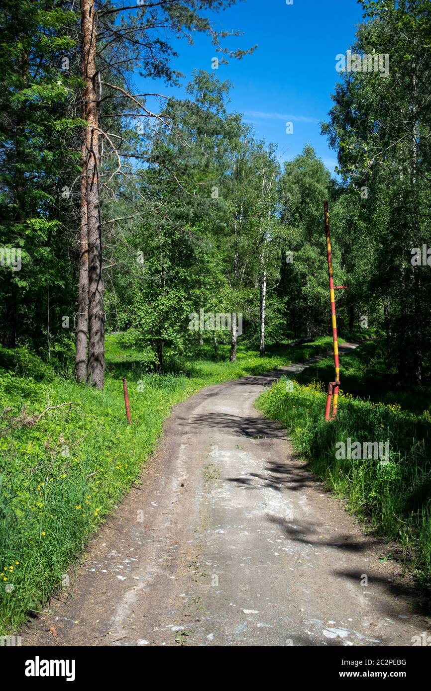 open boom barrier on dirt road in forest Stock Photo - Alamy
