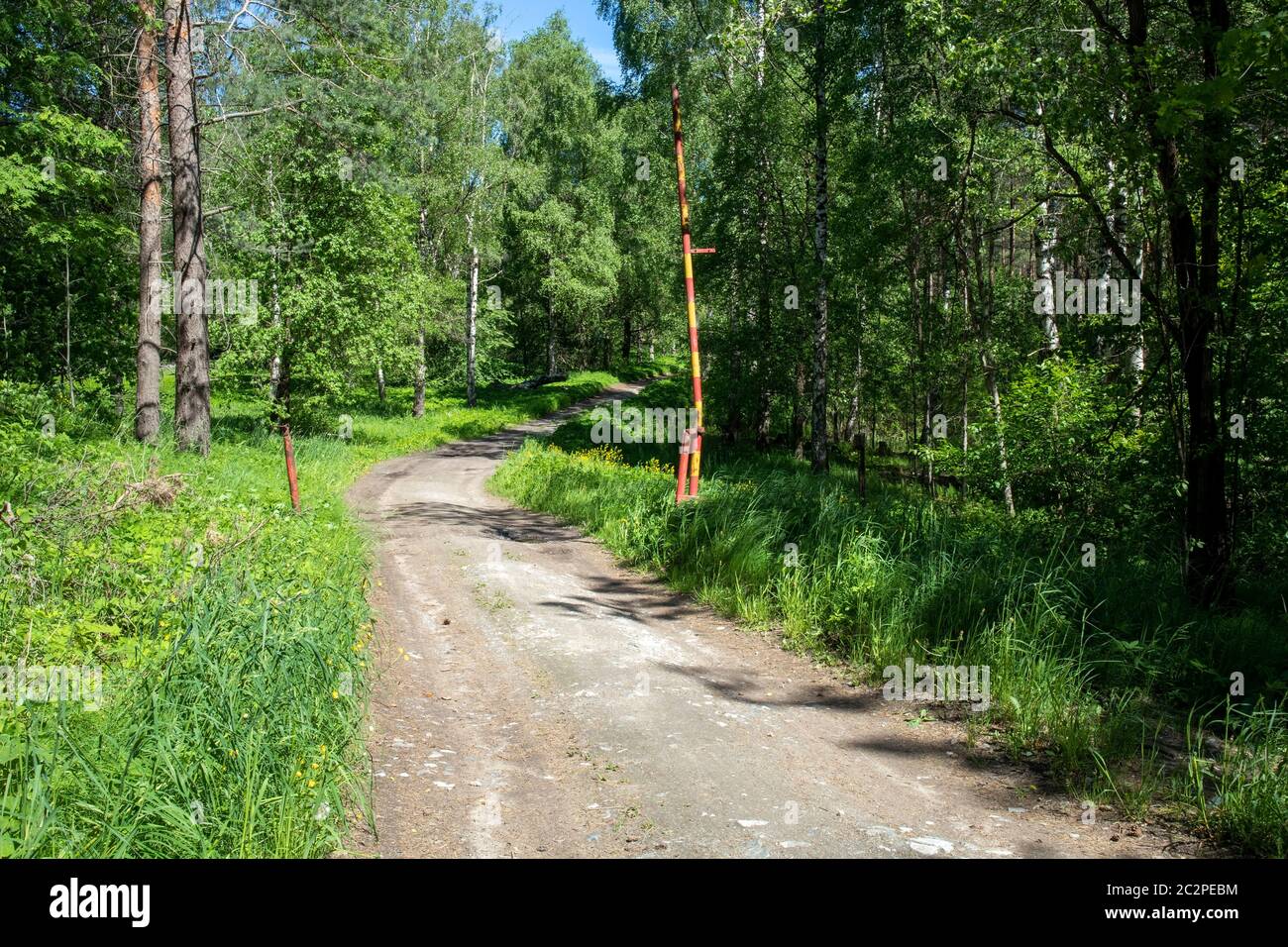 open boom barrier on dirt road in forest Stock Photo - Alamy