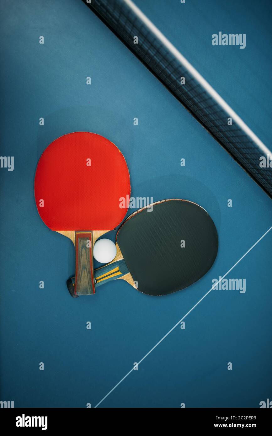 Two tennis rackets and ball on the table closeup, game concept. Ping ...
