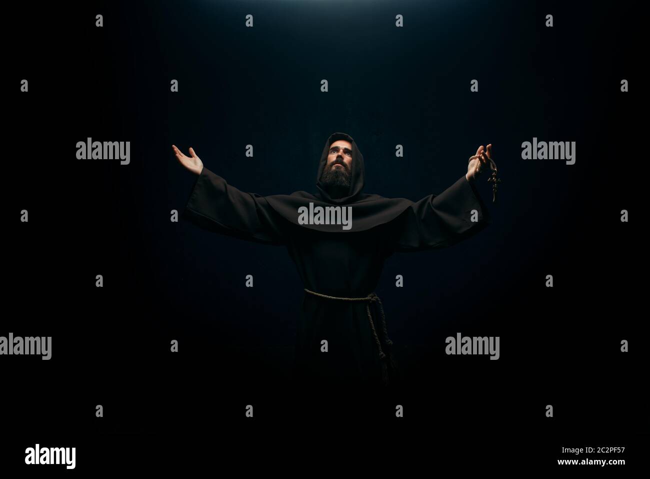 Medieval monk praying to the holy god, religion. Mysterious friar in ...
