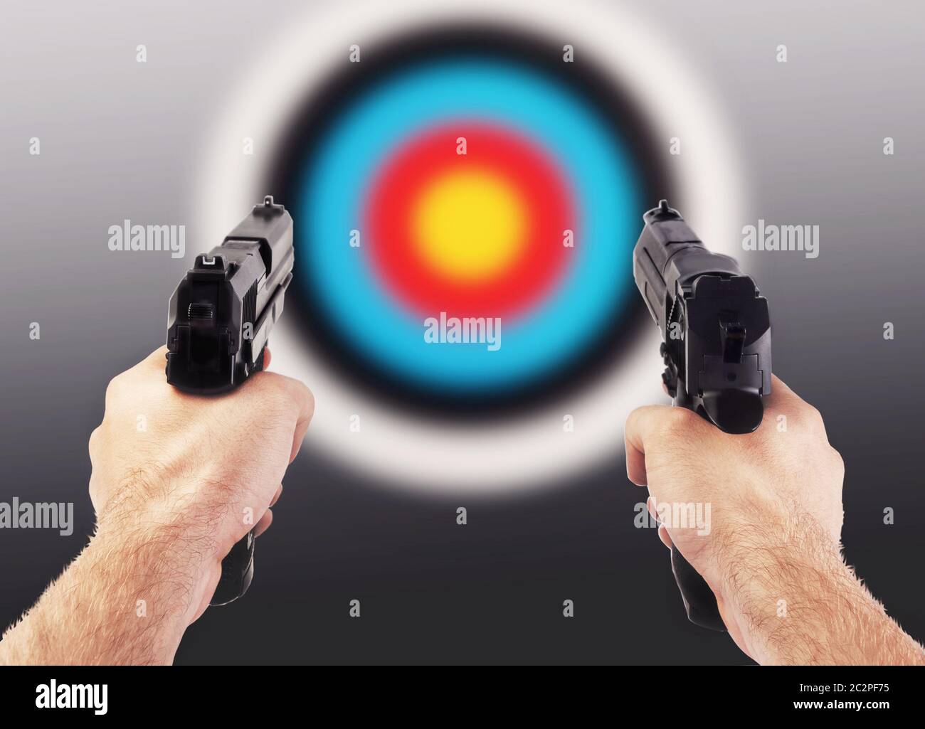 Hands with two guns against colourful shooting target Stock Photo - Alamy