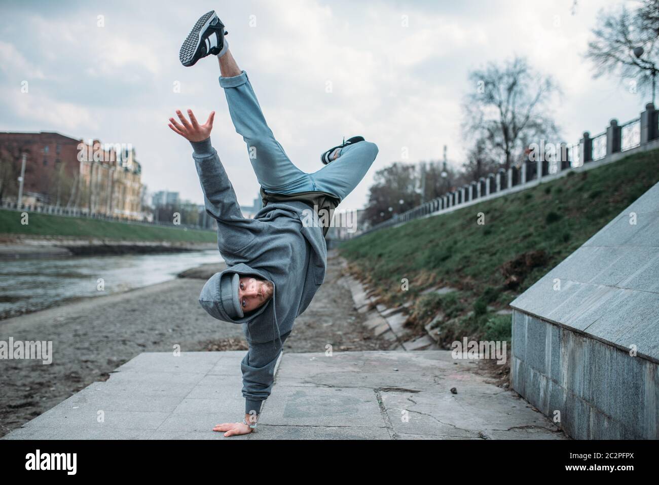 Breakdance performer, upside down motion on the street. Modern dance ...