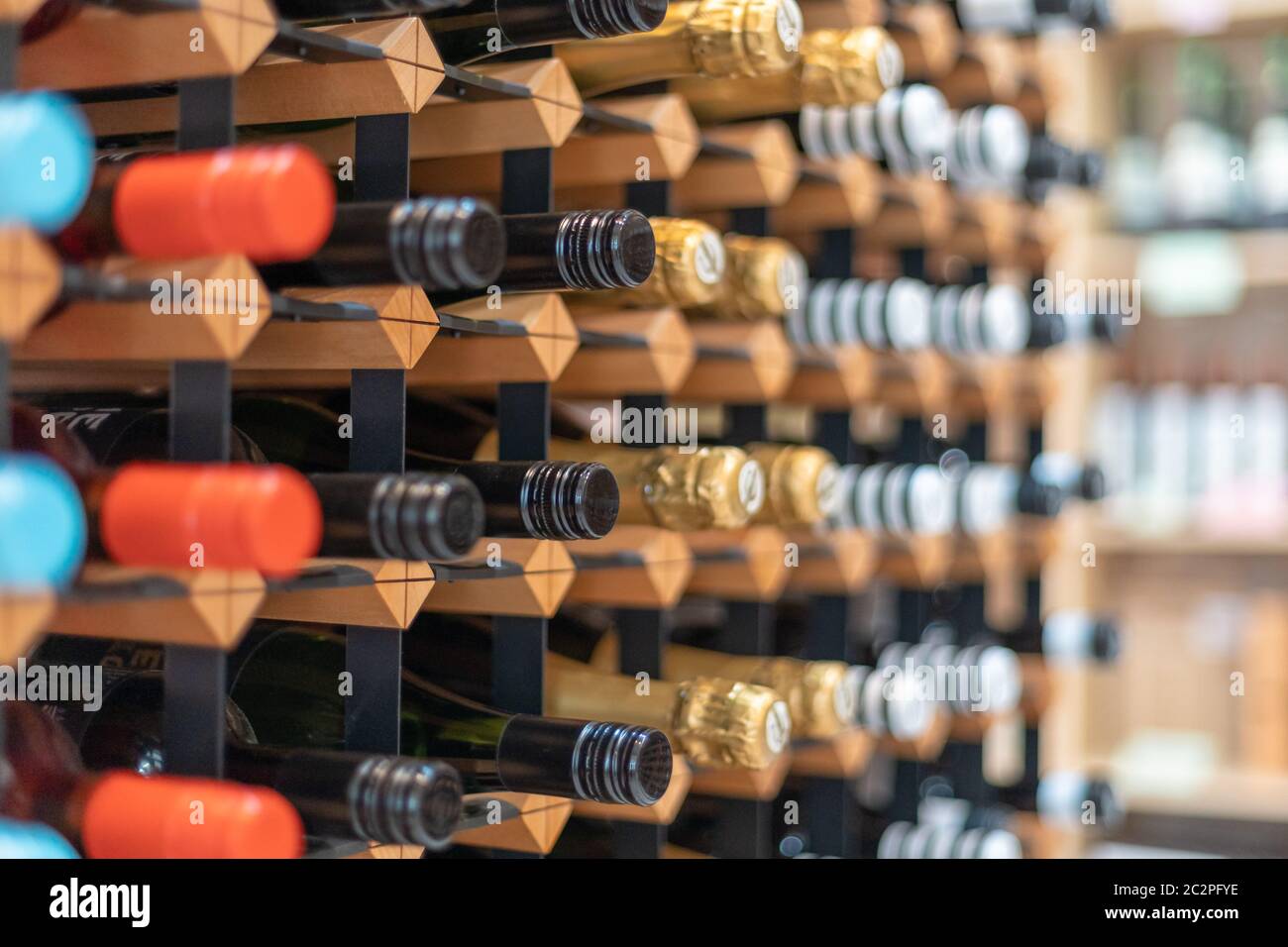 bottles with archive wine in a large shelf in a wine shop Stock Photo ...