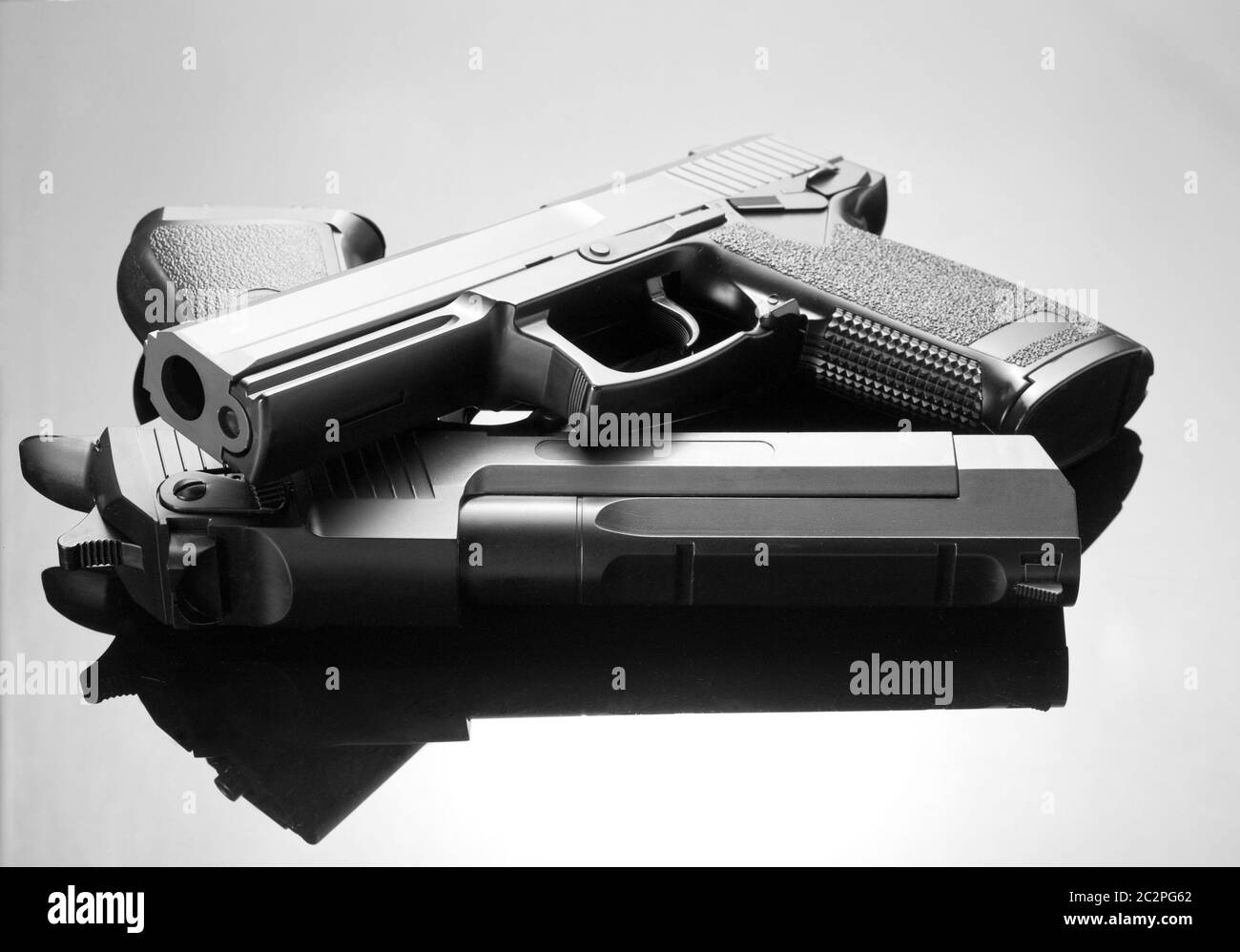 Two handguns. Desert Eagle and M23 Double Eagle Stock Photo - Alamy
