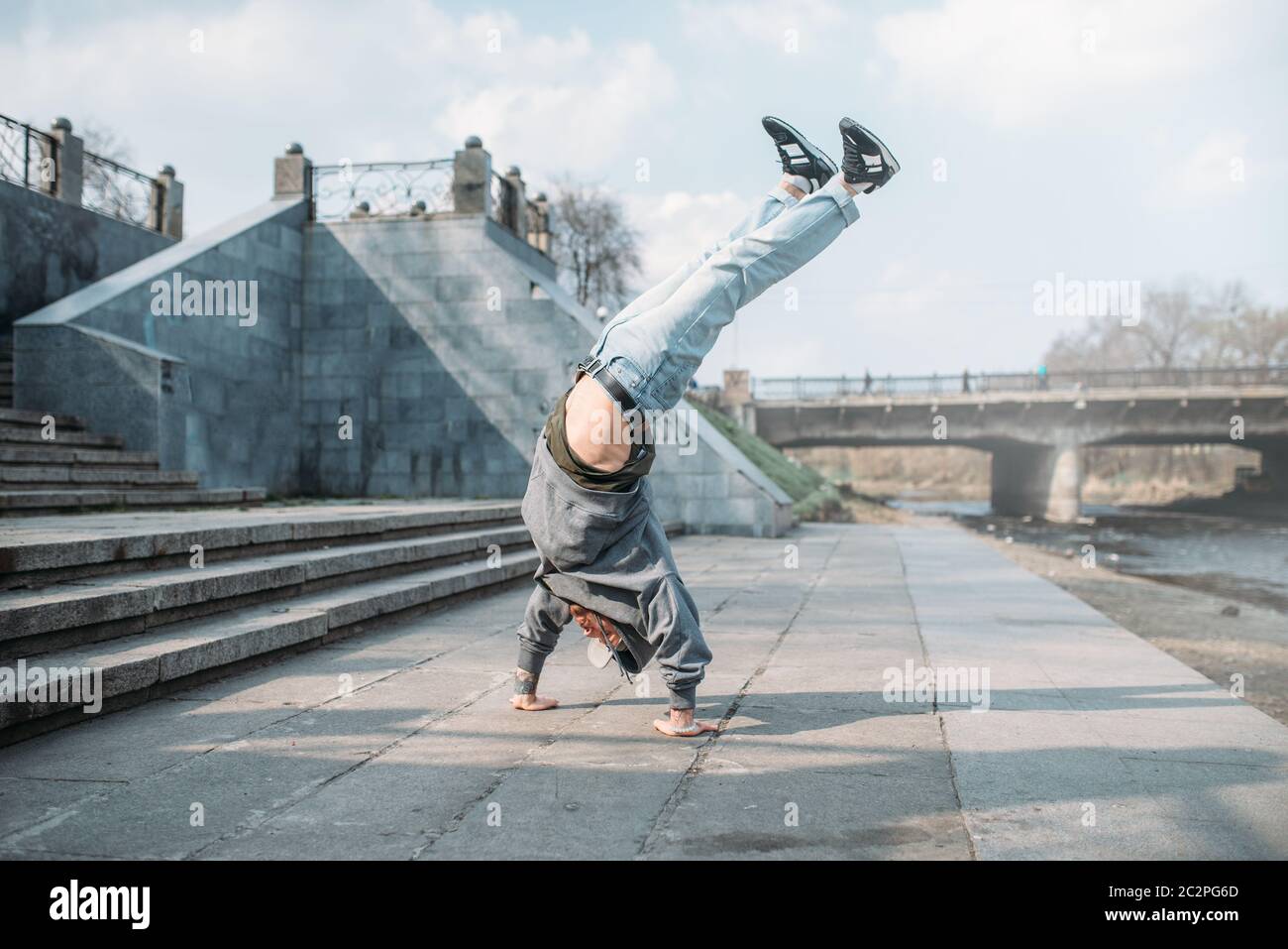 Breakdance performer, upside down motion on the street. Modern dance ...
