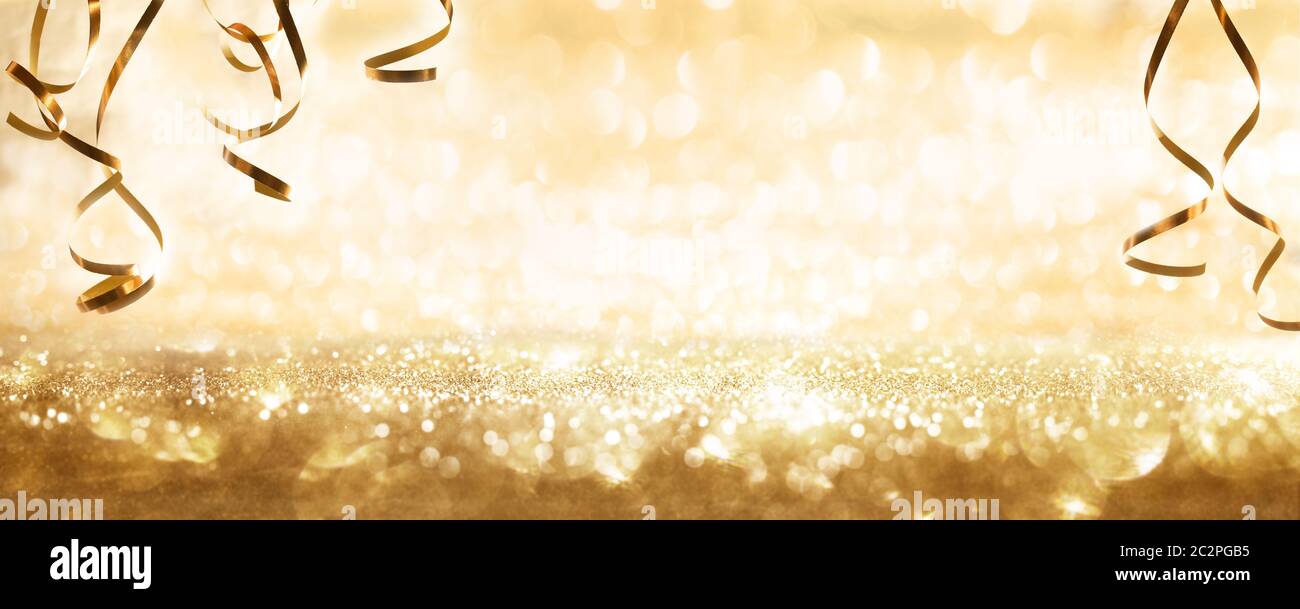 Golden sparkling party background with streamers for a celebratory ...