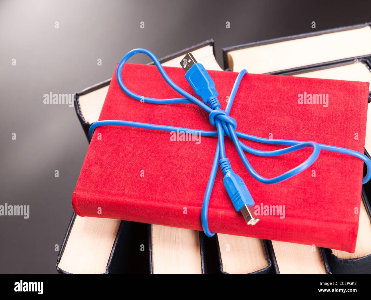 Blue ribbon from the usb cable on the red book Stock Photo - Alamy